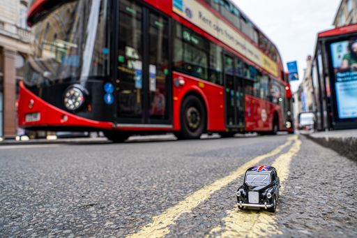 Closeup shot of a traditional black cab driving through the most famous ...