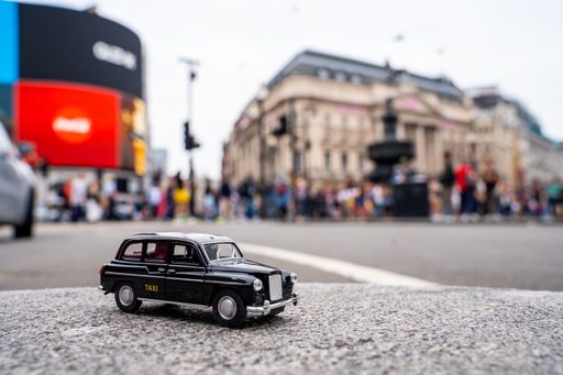Closeup shot of a traditional black cab driving through the most famous ...