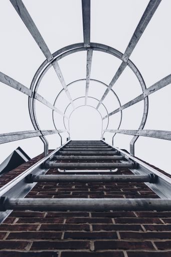Vertical low angle shot of a Fire Metal Staircase on A Building brick ...