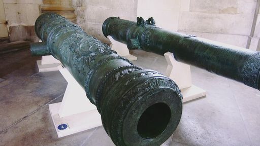 Closeup of two ancient medieval canons with small details on them in a ...